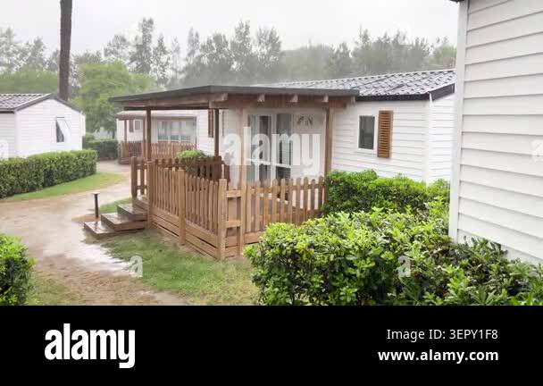 Downpour of torrential rain during a summer thunderstorm over wooden ...