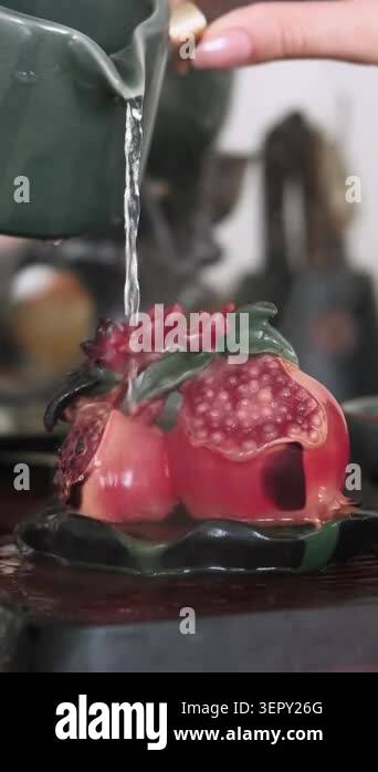 Vertical video. Pomegranate tea figurine. Chinese ceremony. Table with ...
