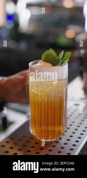 Vertical video. Garnishing cocktail. Bartender service. Mixologist ...
