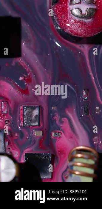 Vertical video. Ink spill. Electronic microchip. Defocused red blue ...