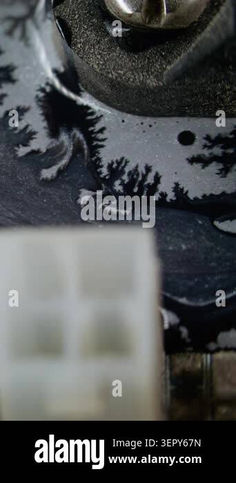 Vertical video. Paint splash. Electronic background. Defocused silver ...