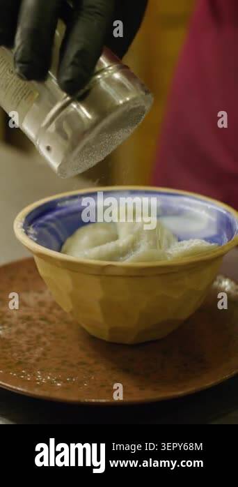 Vertical video. Restaurant service. Culinary process. Chef shaking ...