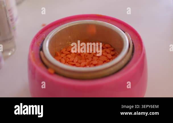 Preparing wax treatment. Skin procedure. Orange product for depilation ...