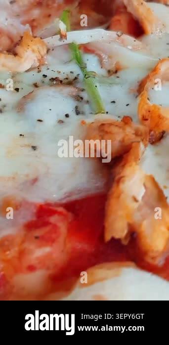 Extreme close-up of a tasty chicken pizza. The camera moves quickly ...