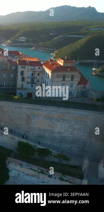 Aerial vertical video of the old medieval houses of a coastal town ...