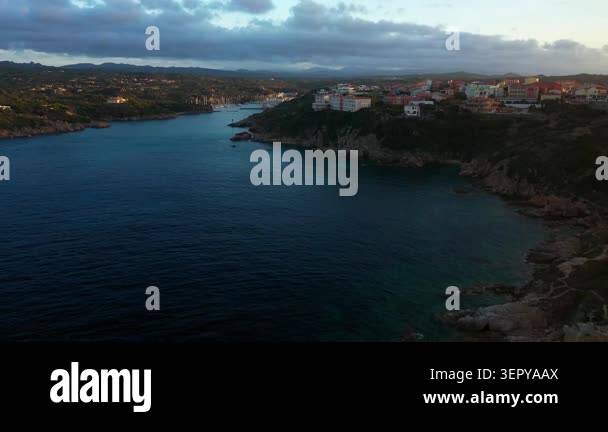 A marina in a beautiful bay between cliffs with charming houses. A town ...