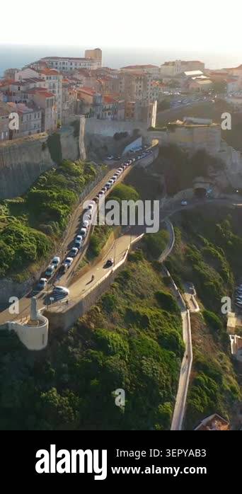 Vertical video of a dangerous serpentine road carved into the rock on ...