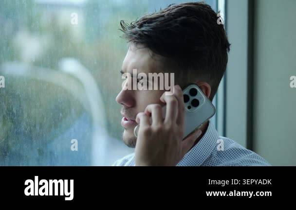 Portrait of male entrepreneur in shirt speaking by smartphone near ...