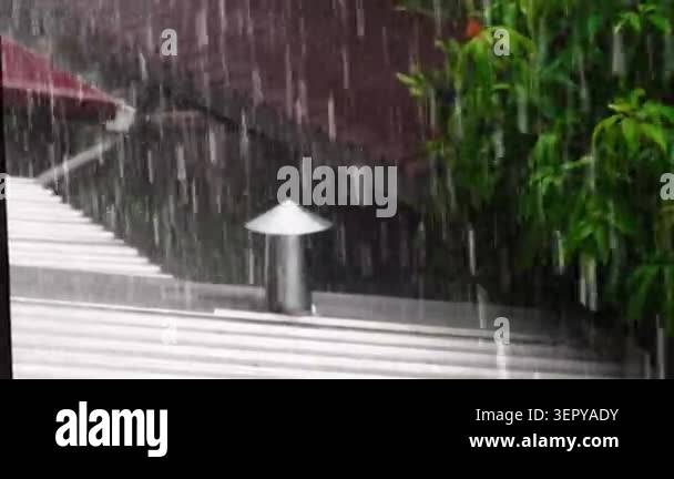 Clear raindrops after a summer rain fall on the roof of a house, a ...