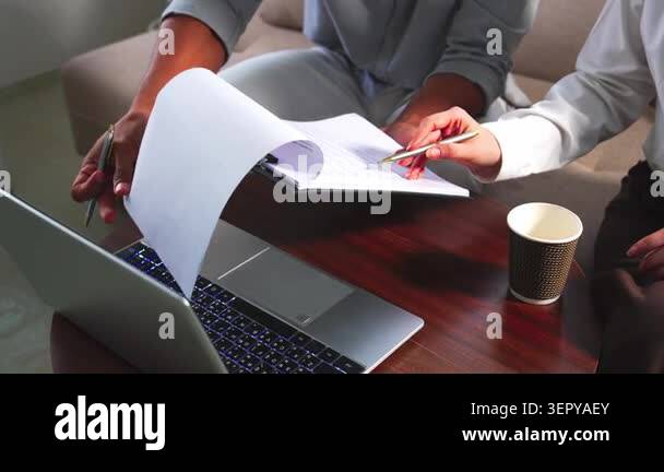 Client pointing at document during business contract signing meeting ...