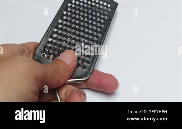 Close up of flat metal cheese grater. Stainless steel kitchen tool ...