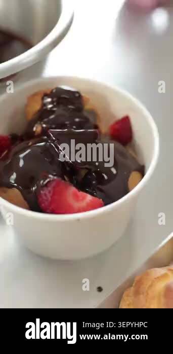Freshly baked cream puff pastries cream in a paper bucket Stock Video ...