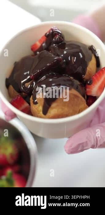 Freshly baked cream puff pastries cream in a paper bucket Stock Video ...