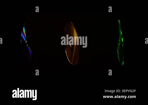Rainbow light reflecting of a surface of a rotating CD-DVD disk against ...