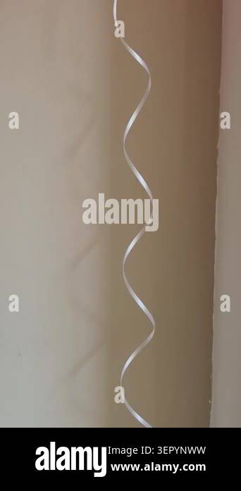 Pink and white balloons with white ribbons create a simple festive ...