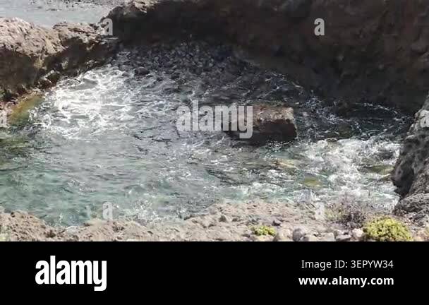 Picturesque view of the natural volcanic pool Charco del Viento with ...
