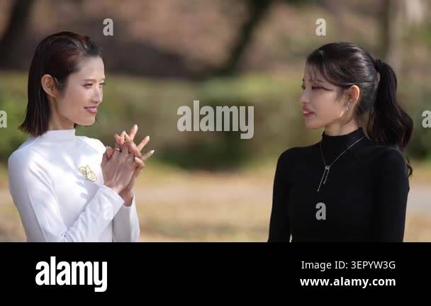 Two women talking outdoors in natural setting Stock Video Footage - Alamy