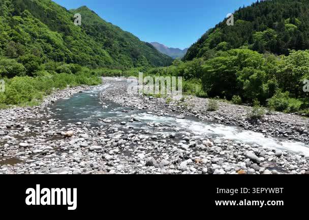 Clear river flowing through green mountainous landscape Stock Video ...
