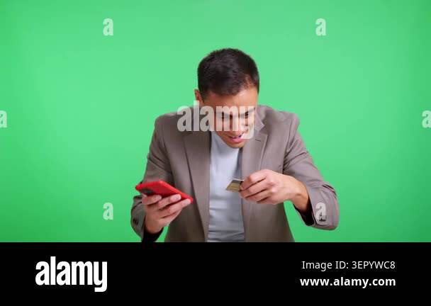 Happy businessman shopping online with a credit card and a smartphone ...