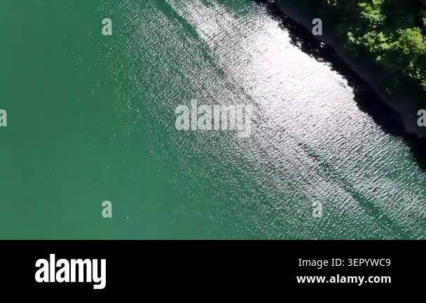 Shimmering water reflecting sunlight near shoreline Stock Video Footage ...