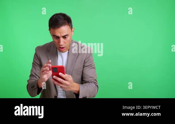 Businessman reading some good news on his mobile phone and celebrating ...