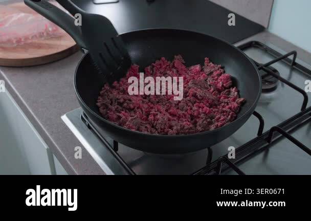 Footage, of the preparation, of bolognese sauce, adding herbs through ...