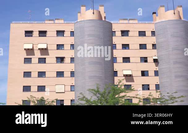 Modern residential building with two tall cylindrical towers. Light ...