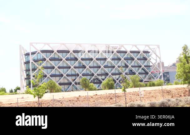 Modern office building featuring a distinctive white lattice facade and ...