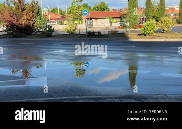 Madrid, Spain, June 9-2026: Urban street after rainfall with large ...