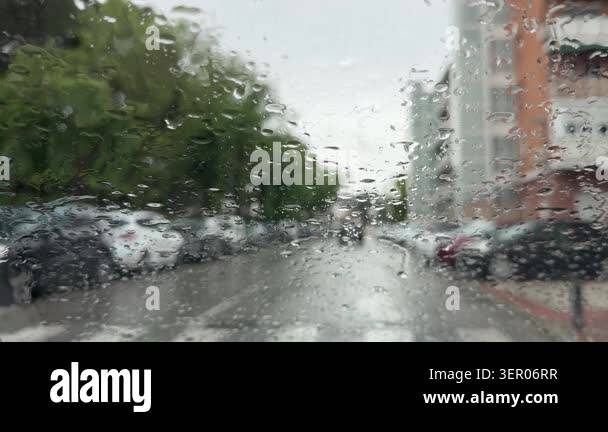 Raindrops on Car Windshield with Blurred City Street Background Stock ...