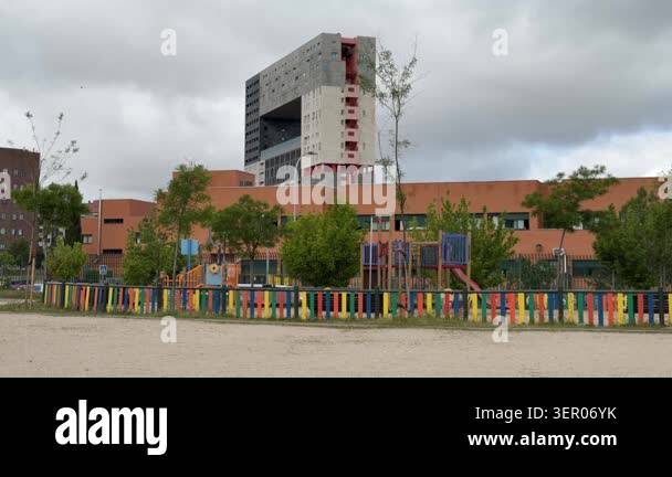 Madrid, Spain, June 9-2026: Urban school playground with colorful fence ...