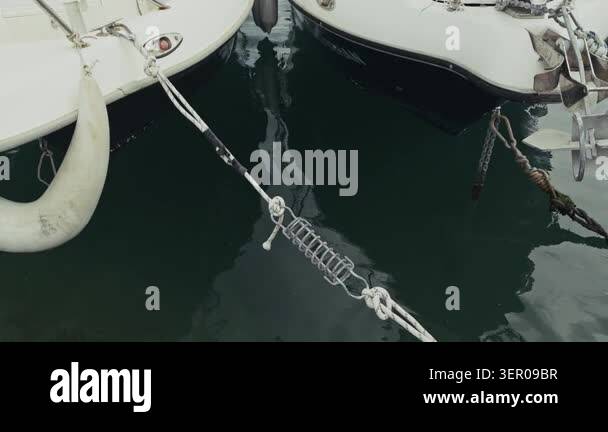 Close up view of a mooring line spring securing a boat at the harbor ...
