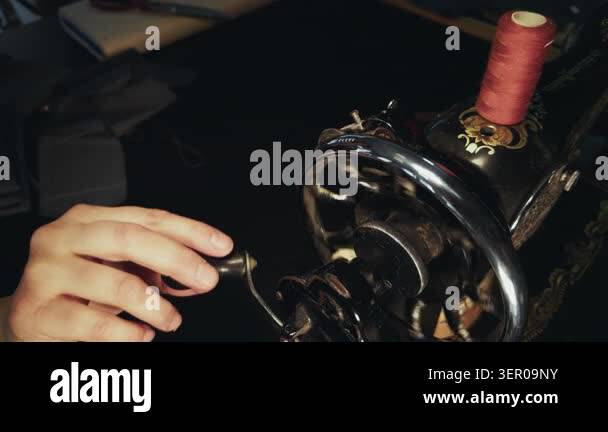 Close up view of a vintage golden tailor sewing machine in a workshop ...