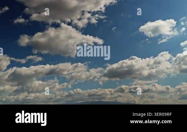 Soft rain clouds moving across the sky in timelapse, showing gentle ...