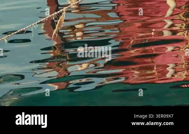 A cinematic close up of a calm sea water surface capturing vibrant and ...