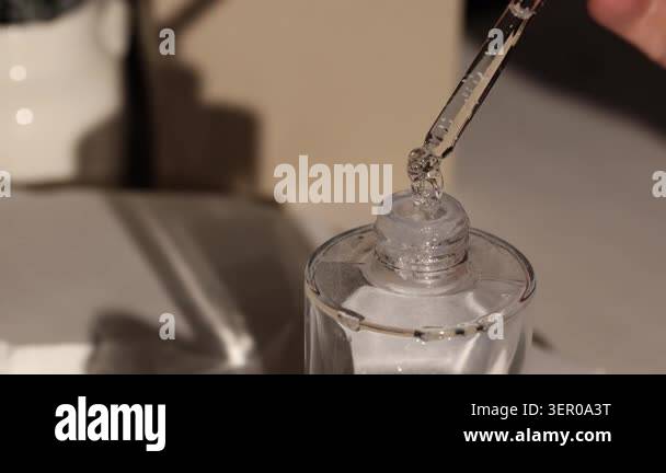 A person uses a dropper to release liquid from a bottle. The process ...