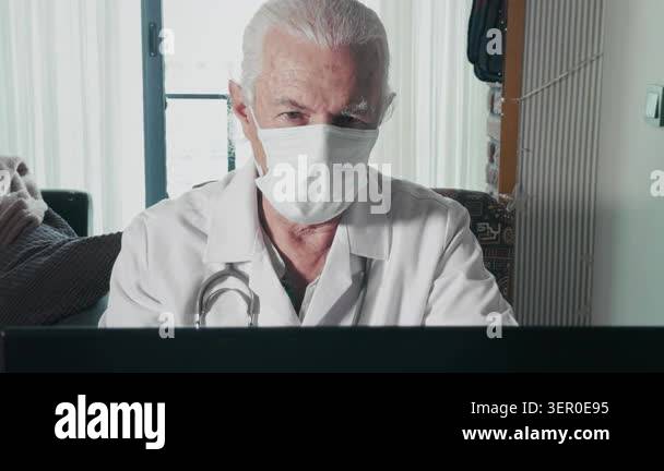 Professional doctor wearing a medical protection mask working on a ...
