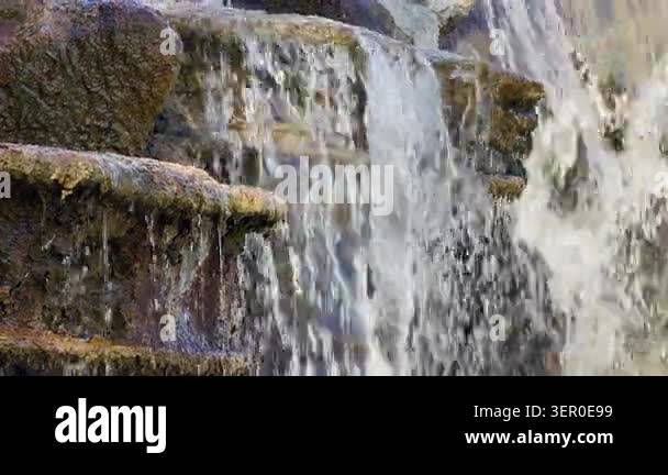 Scenic high-angle view looking down on a cascading waterfall from wet ...
