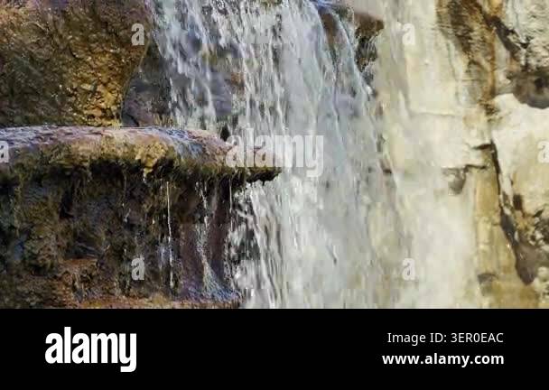 Scenic high-angle view looking down on a cascading waterfall from wet ...