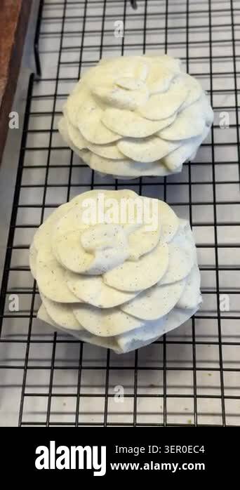 Two delicate desserts crafted to resemble blooming roses feature smooth ...