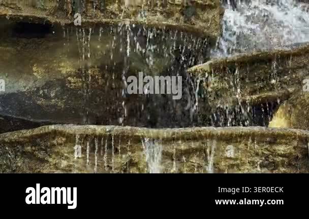 Scenic high-angle view looking down on a cascading waterfall from wet ...
