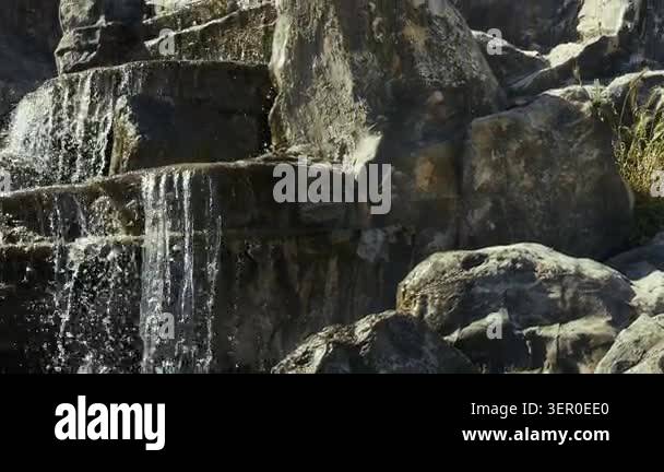 Scenic high-angle view looking down on a cascading waterfall from wet ...