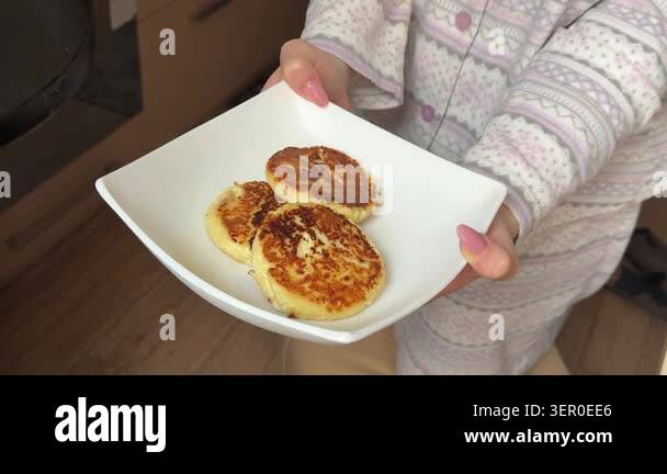 Homemade cottage cheese pancakes sizzle on a black cast iron pan as ...
