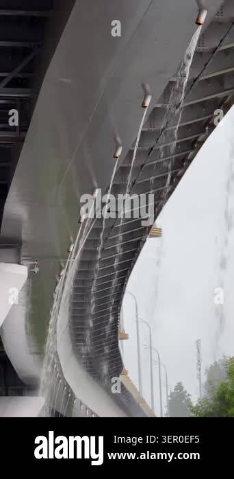 Rain pours from the gutters of the road bridge Stock Video Footage - Alamy