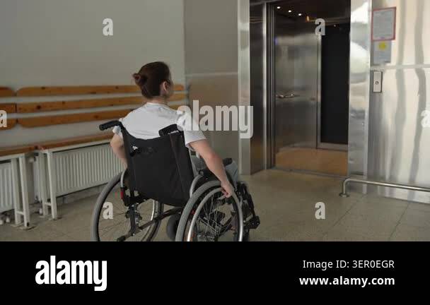 A Caucasian woman in a wheelchair uses an elevator Stock Video Footage ...