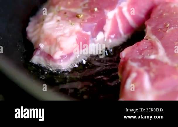 Chef cook sets stewpan meat steak on frying pan. Making delicious ...
