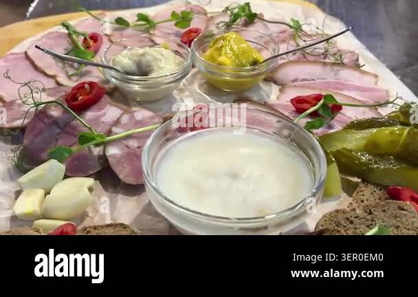 Assorted meats, sliced lard, garlic, pickled cucumbers, mustard, bread ...
