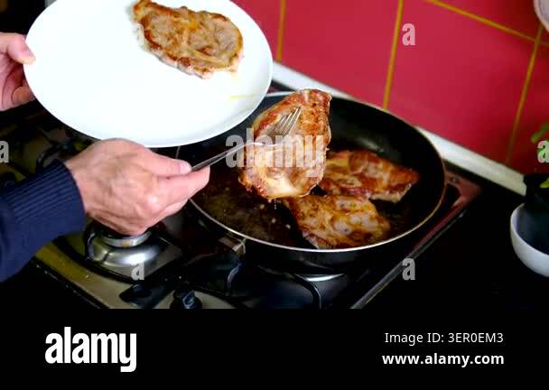 Chef cook sets stewpan meat steak on frying pan. Making delicious ...