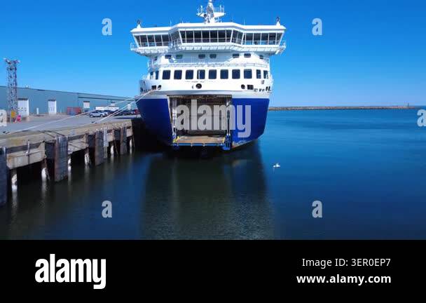 Detailed drone view of a passenger ferry at berth with boarding ramp ...