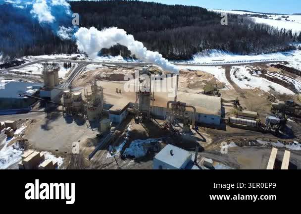 Winter drone view of a large lumber production site, featuring timber ...
